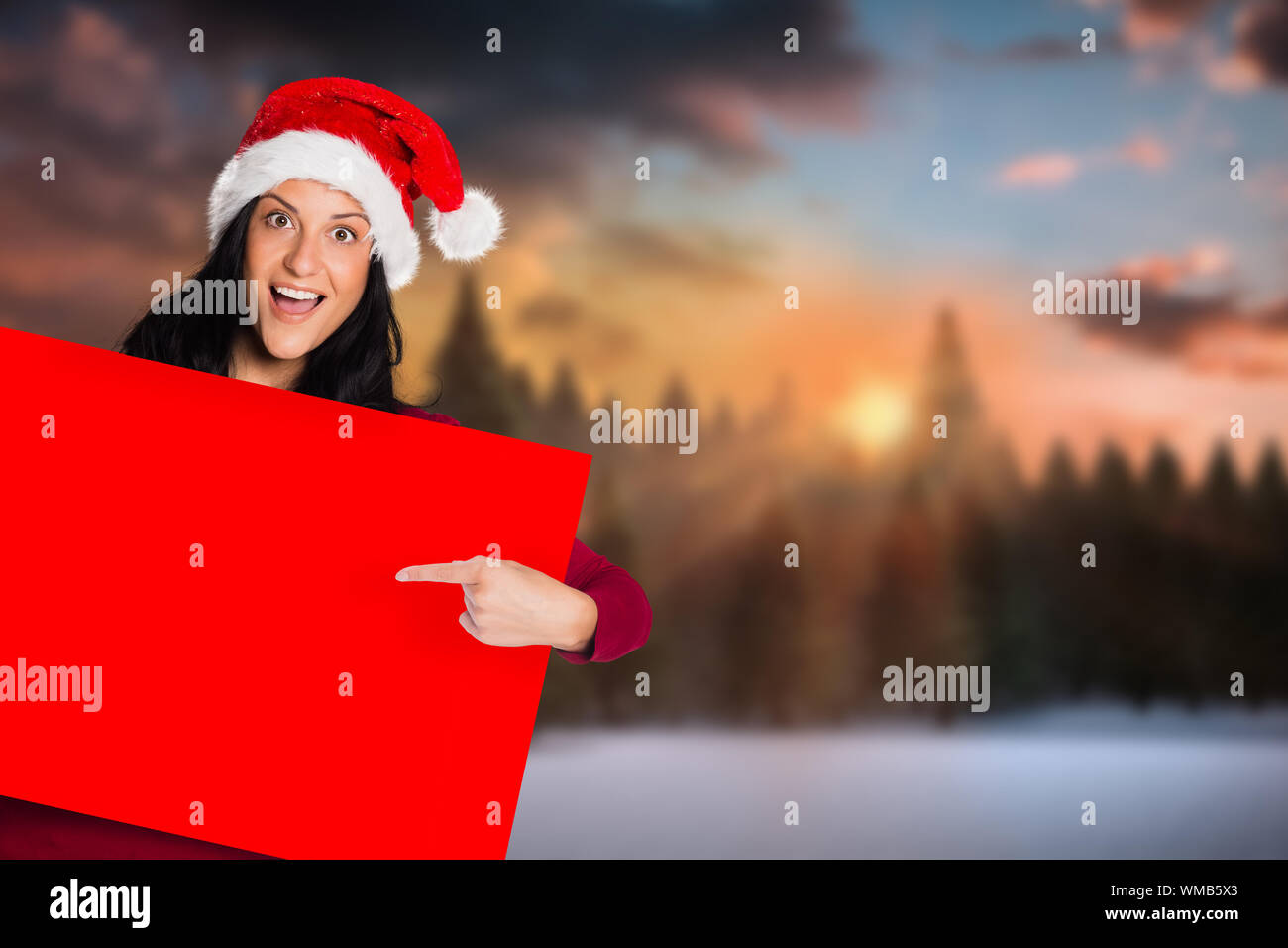 Woman pointing at sign against festive background Stock Photo - Alamy