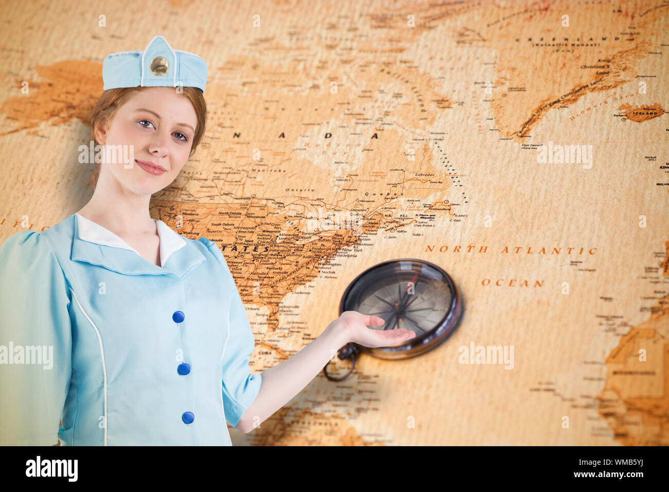 Pretty air hostess presenting with hand against world map with compass ...