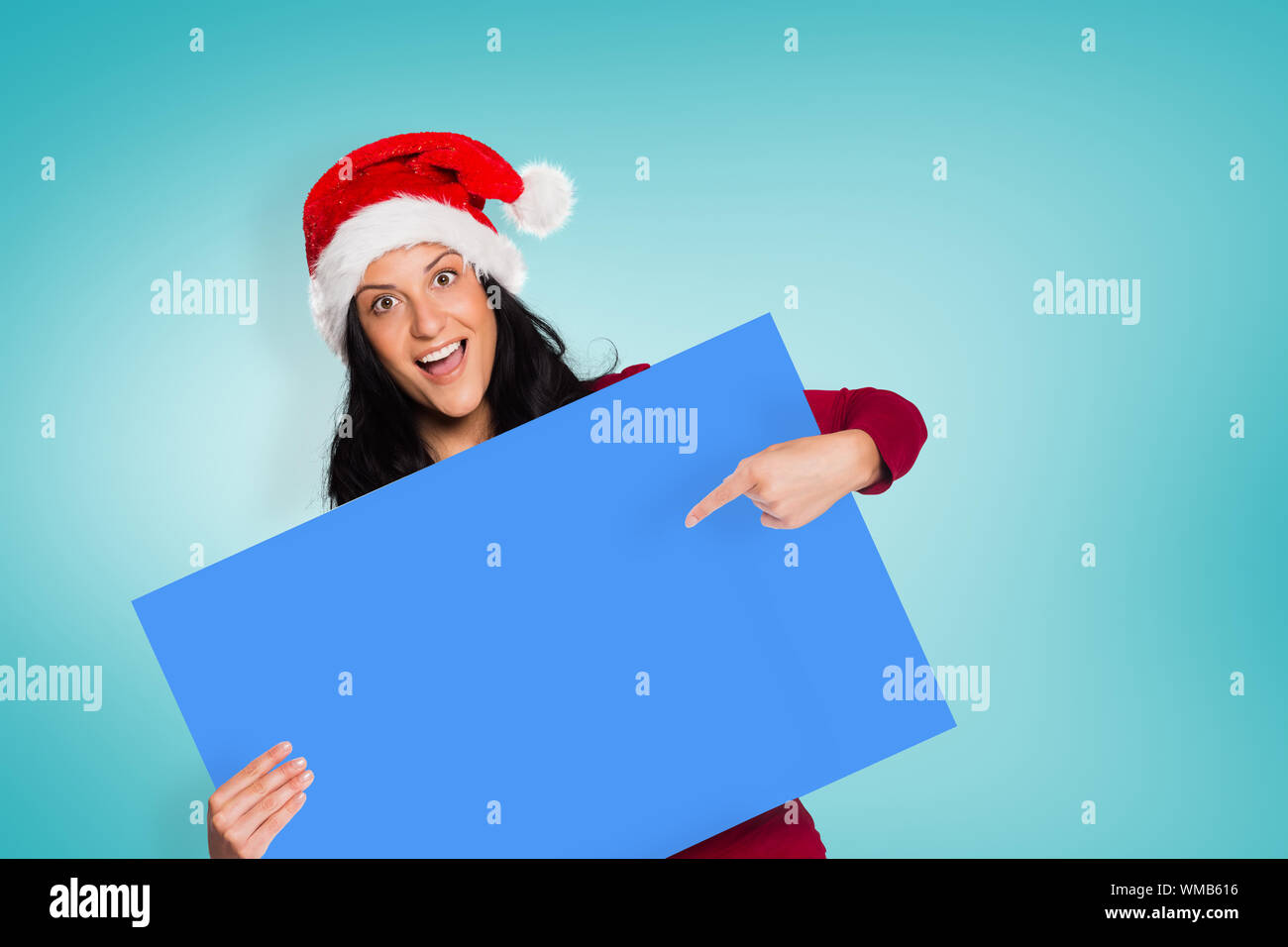 Woman pointing at sign against blue vignette Stock Photo - Alamy