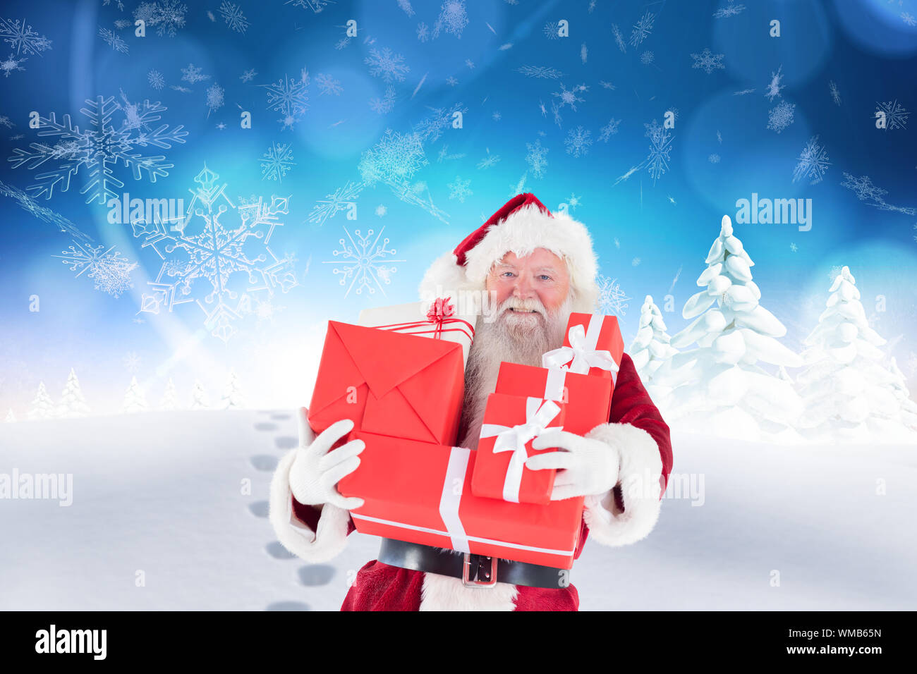 Santa carrying gifts in the snow against snowy landscape with fir trees ...