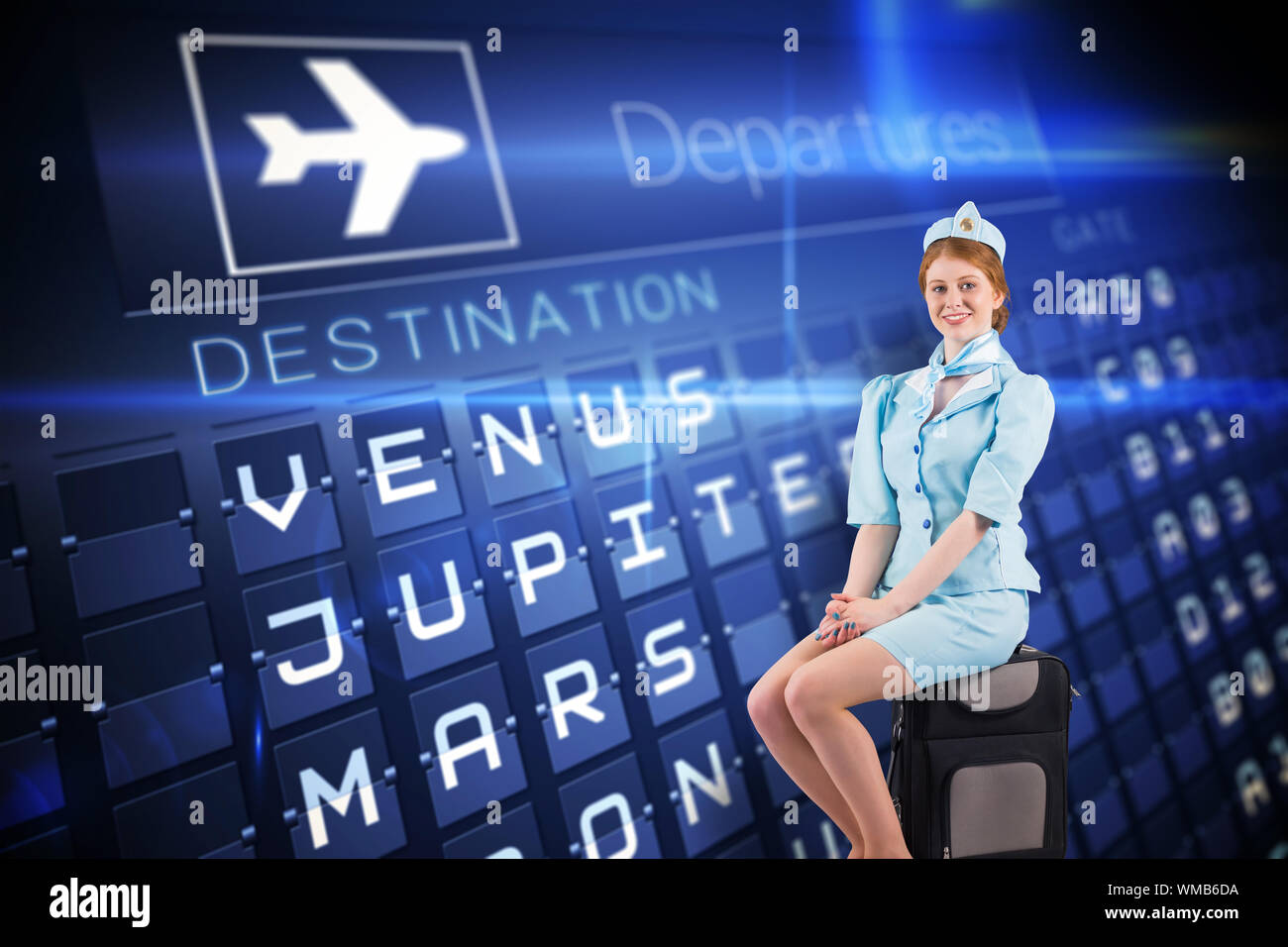 Pretty air hostess smiling at camera against blue departures board for ...