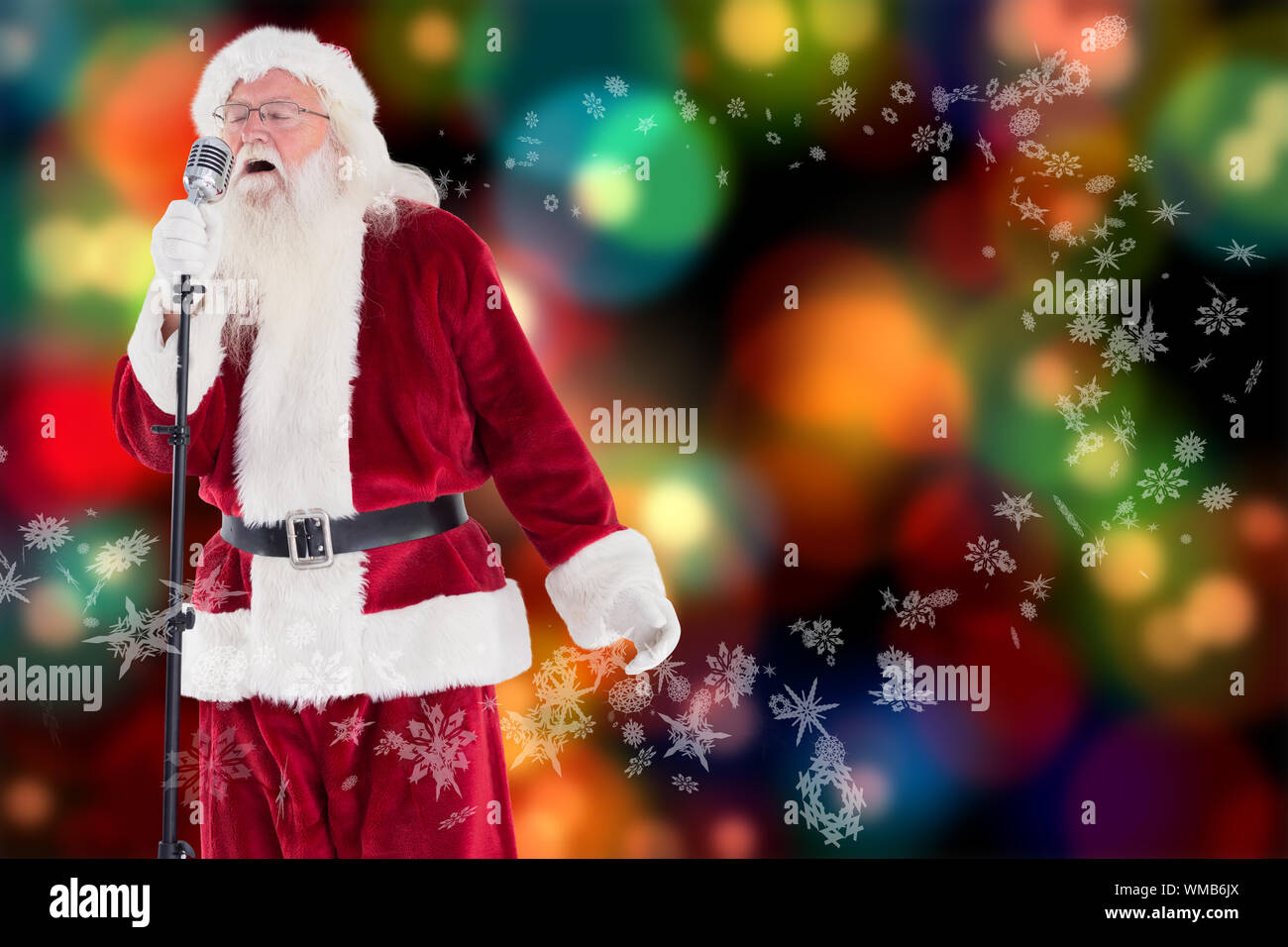 Santa sings like a Superstar against colourful glowing dots on black ...