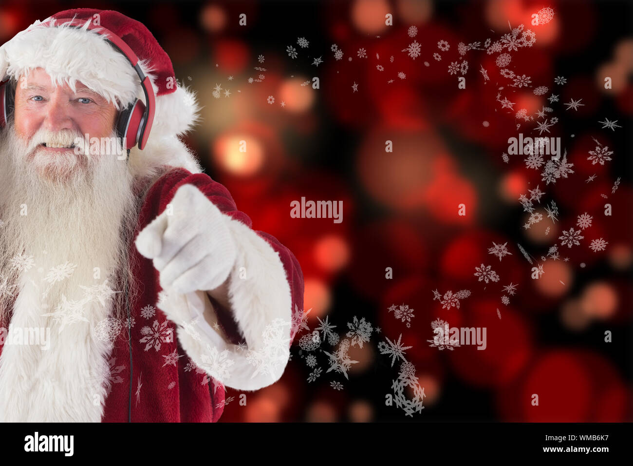 Santa is listening some music against red glowing dots on black Stock ...