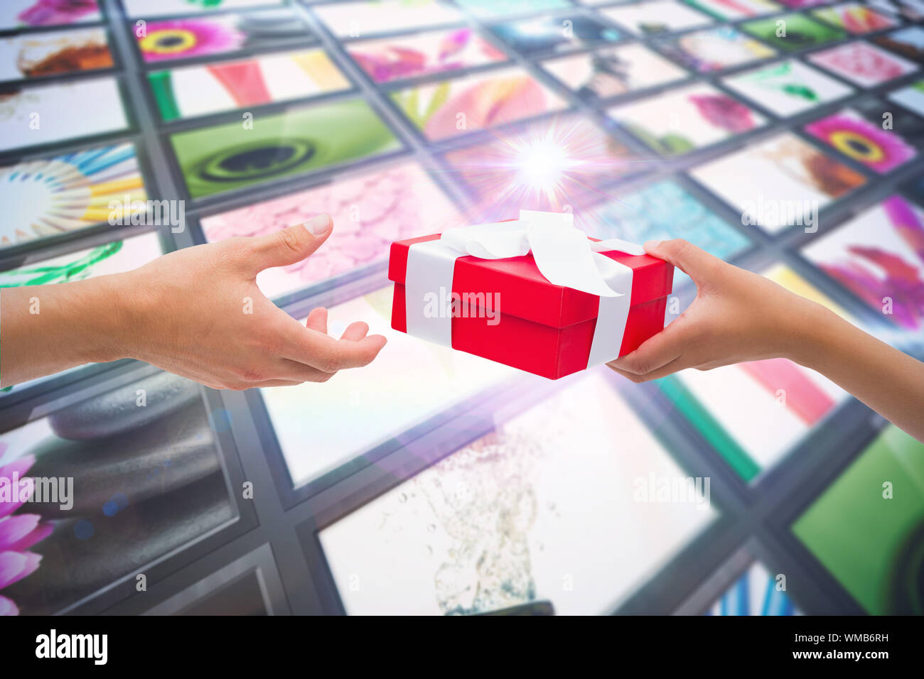 Couple passing a wrapped gift against screen collage showing lifestyle ...