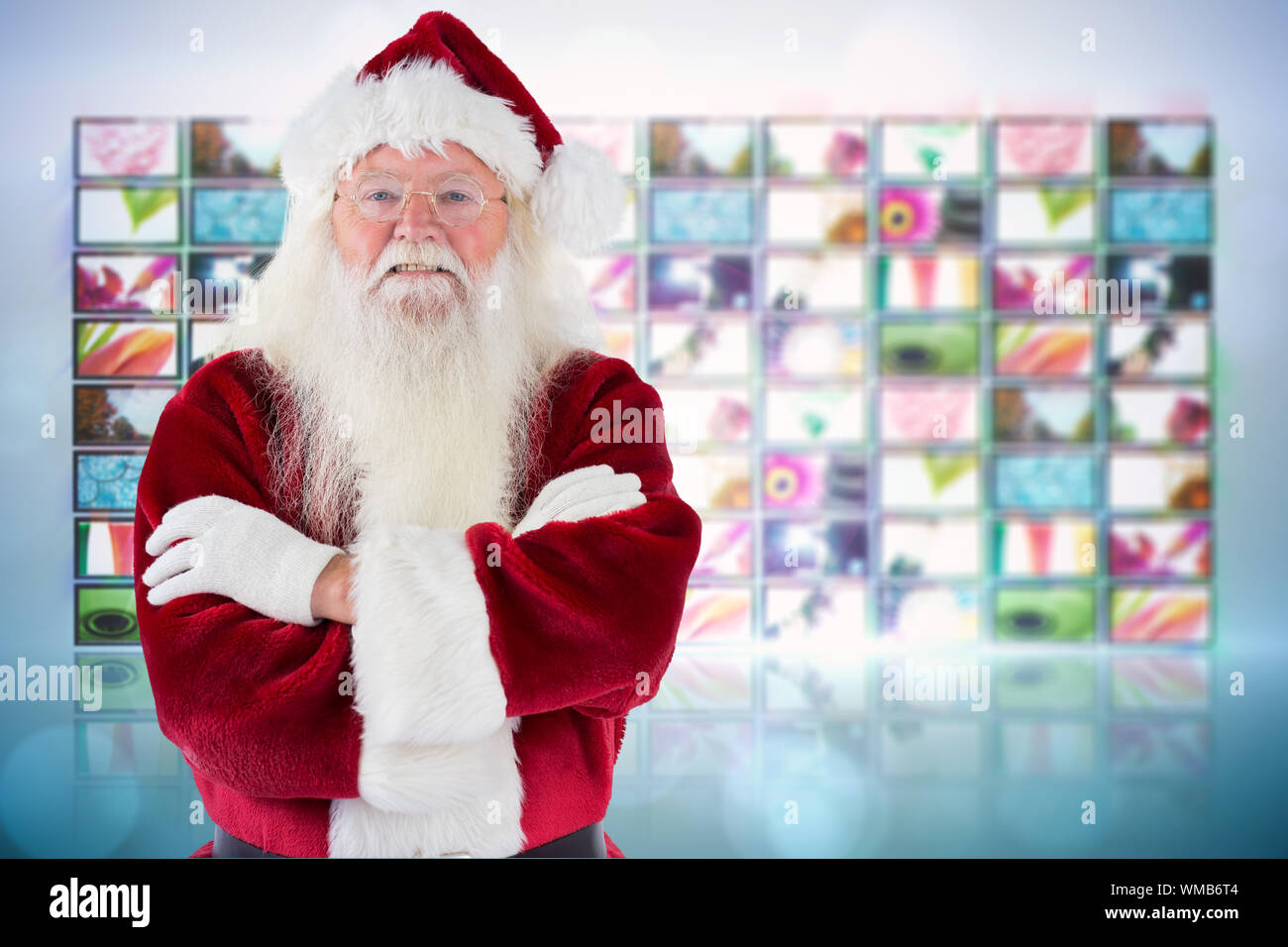 Santa smiles with folded arms against screen collage showing lifestyle ...