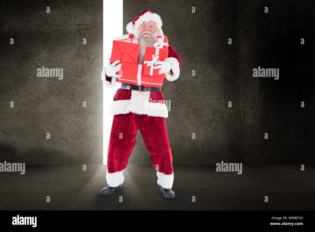 Santa carries a few presents against door in dark room Stock Photo - Alamy