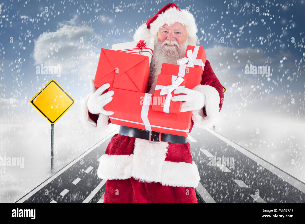 Santa carries a few presents against road over clouds with road signs ...