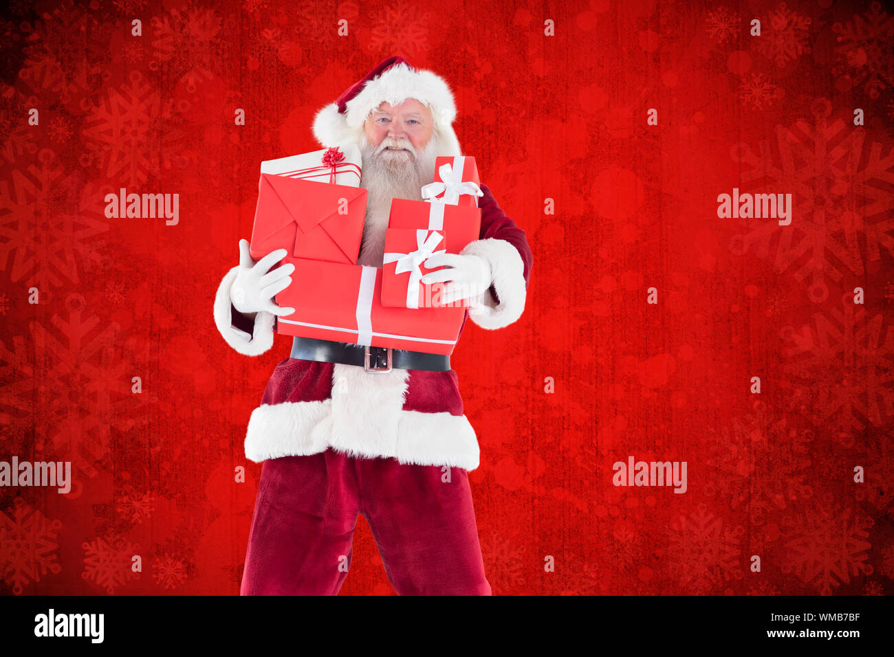 Santa carries a few presents against red paint splatter background ...