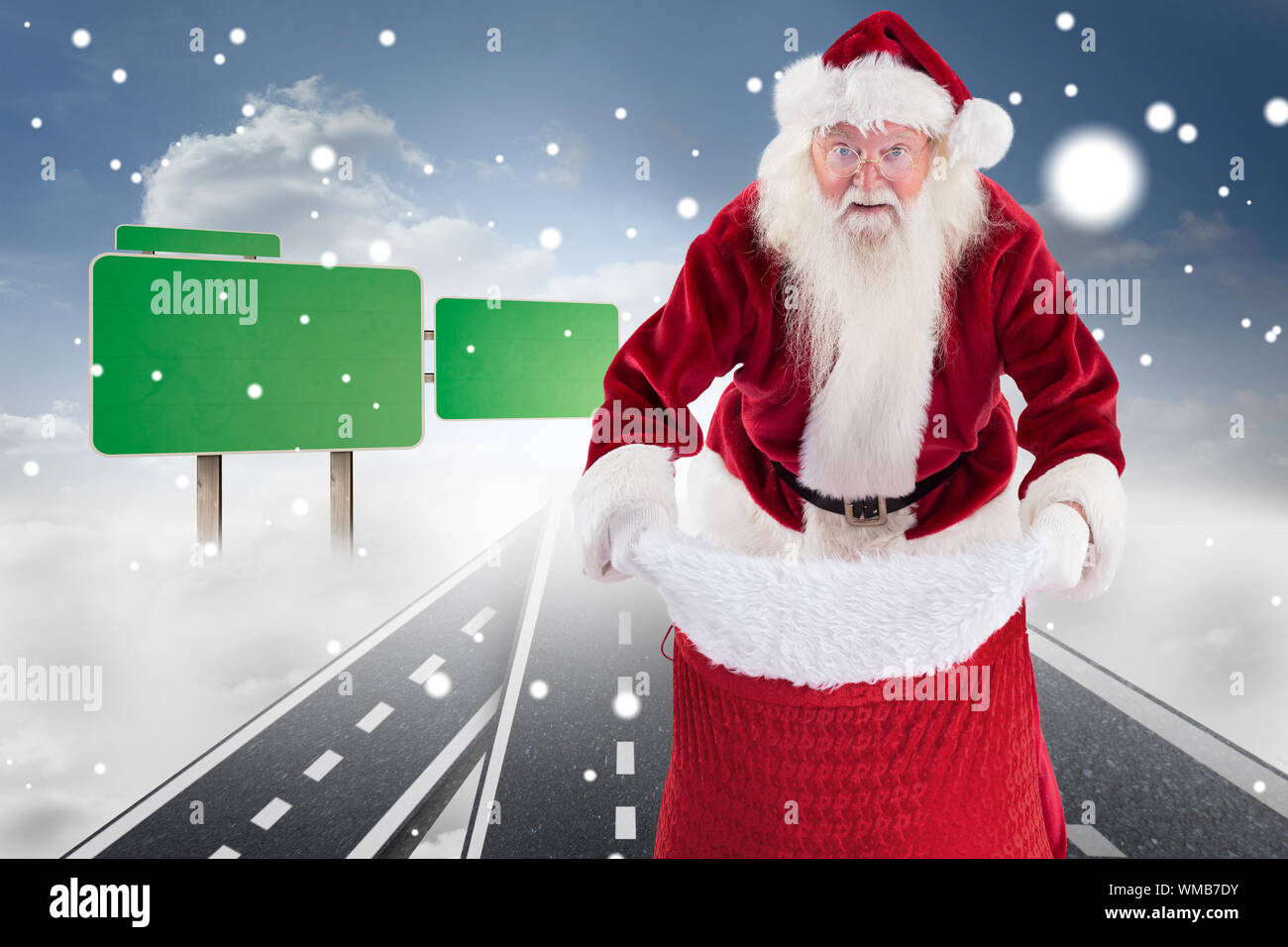 Santa open his red bag against roads over clouds with empty signposts ...