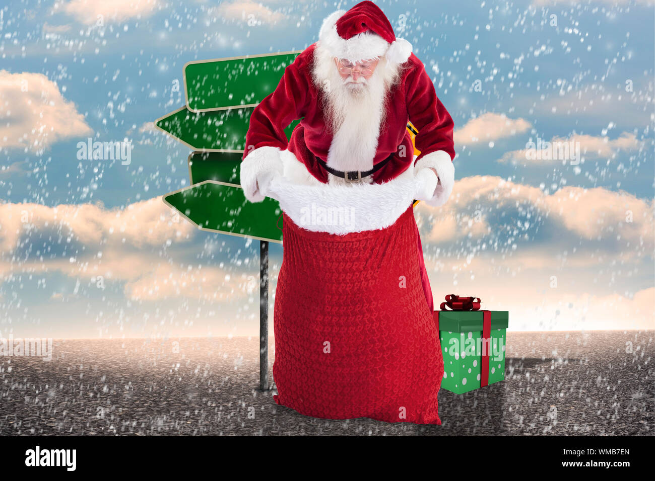 Santa looks in his bag against two types of empty signposts Stock Photo ...