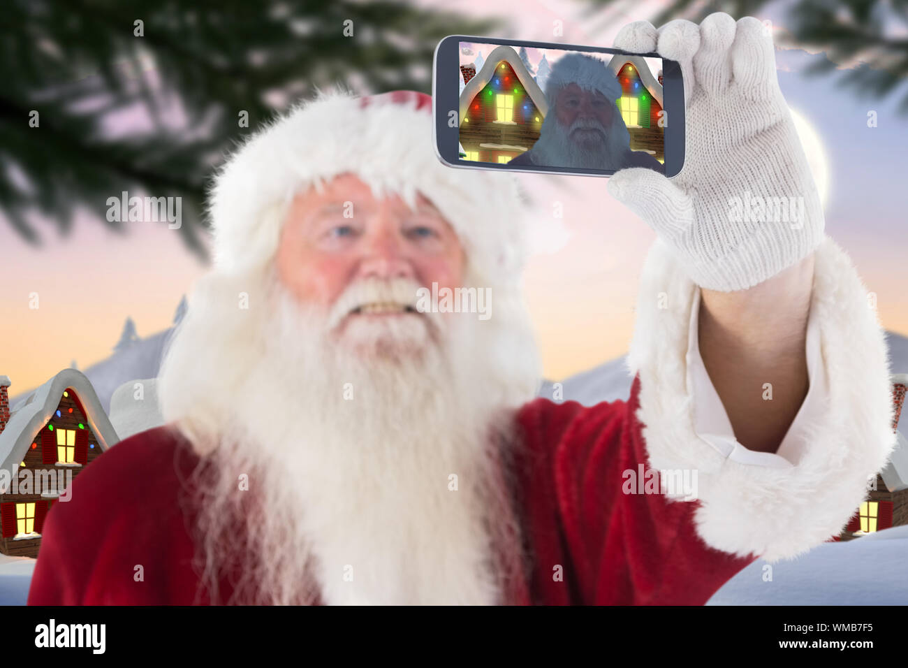 Santa taking a selfie on phone against cute christmas village with tree ...