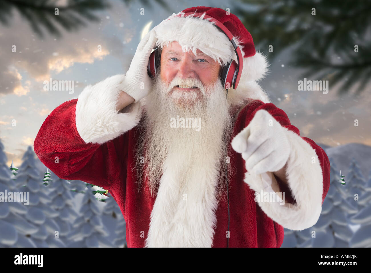 Santa is listening some music against cute christmas village at north ...