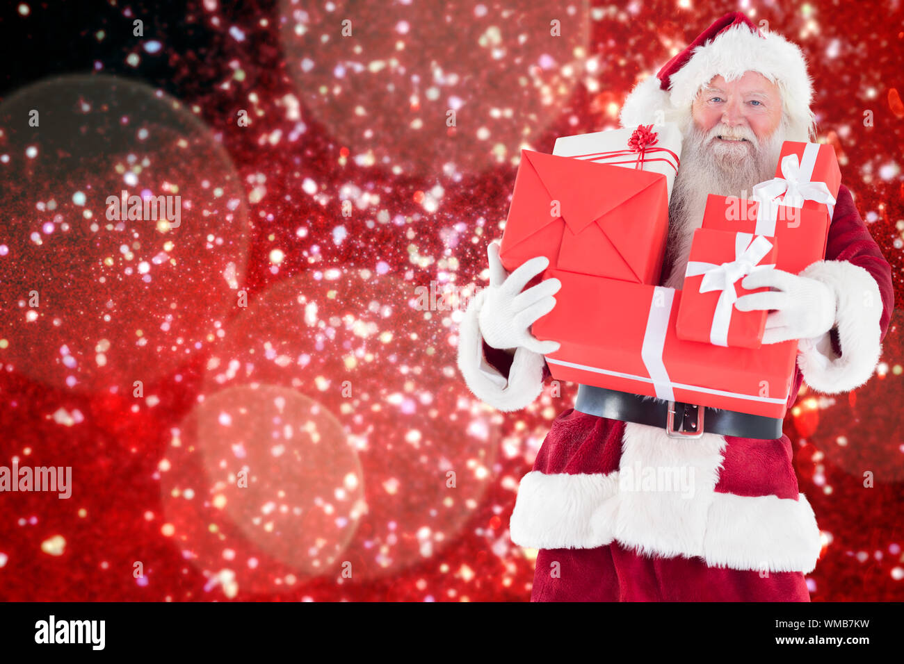 Santa carries a few presents against white snow and stars on red Stock ...