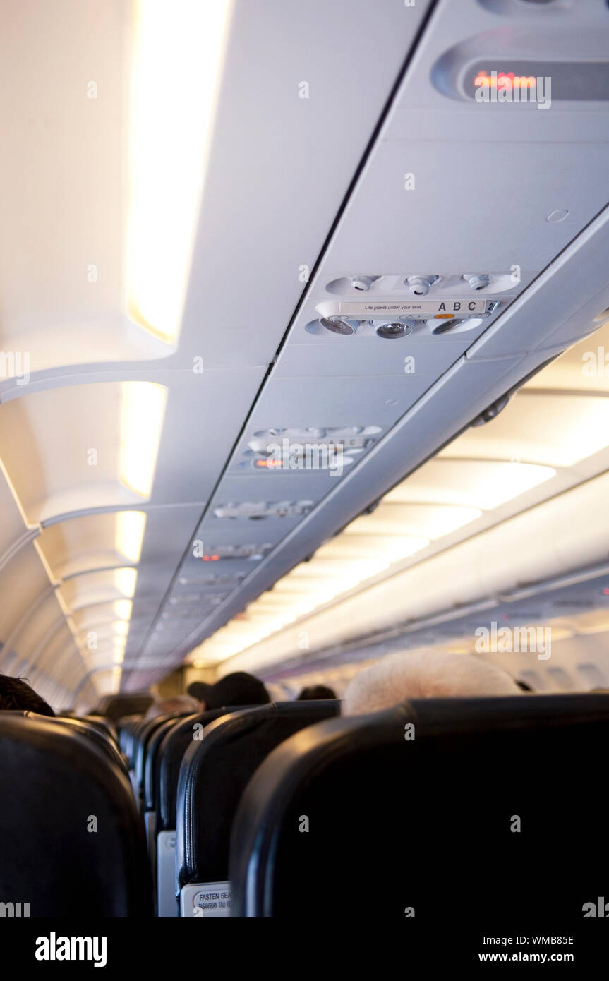 Airplane cabin interior with passengers during the flight Stock Photo ...