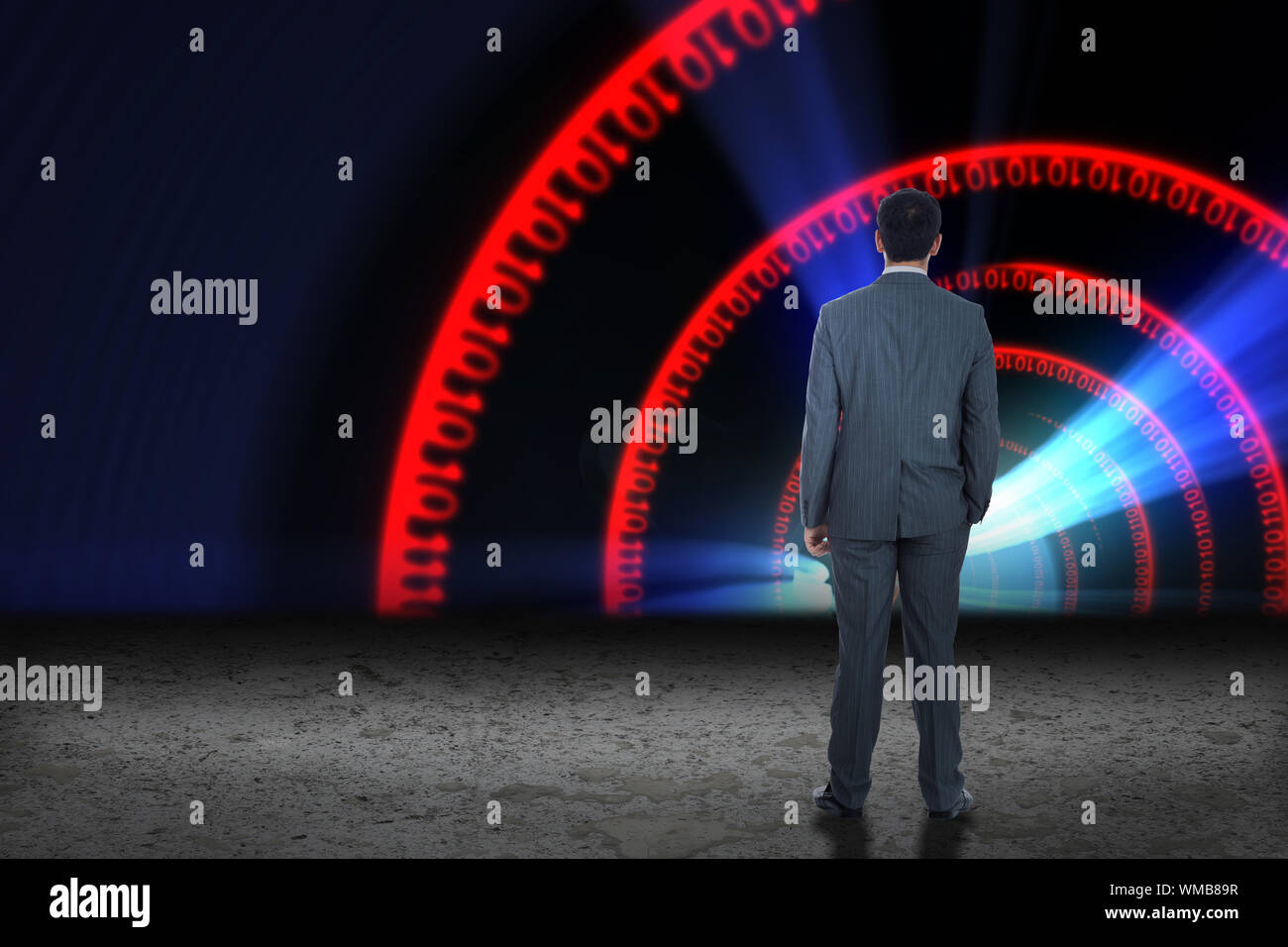 Businessman standing against binary code tunnel in red Stock Photo - Alamy