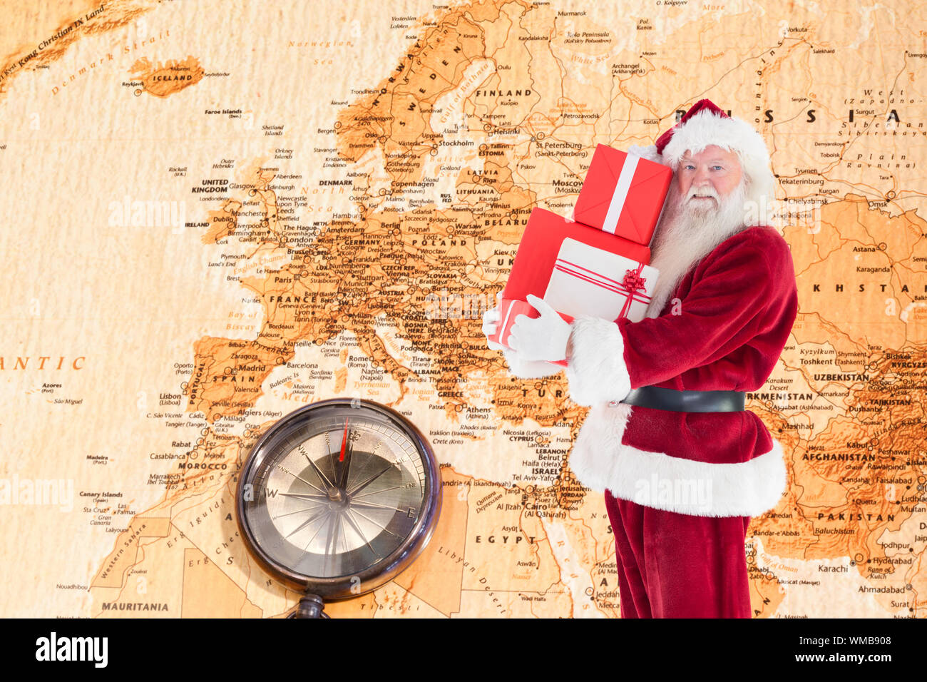 Santa carries a few presents against world map with compass showing ...
