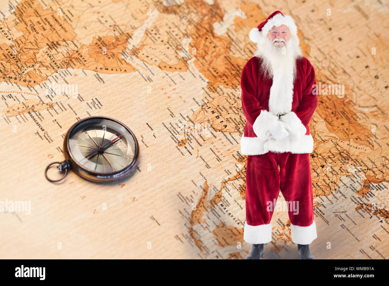Jolly Santa smiling at camera against world map with compass showing ...