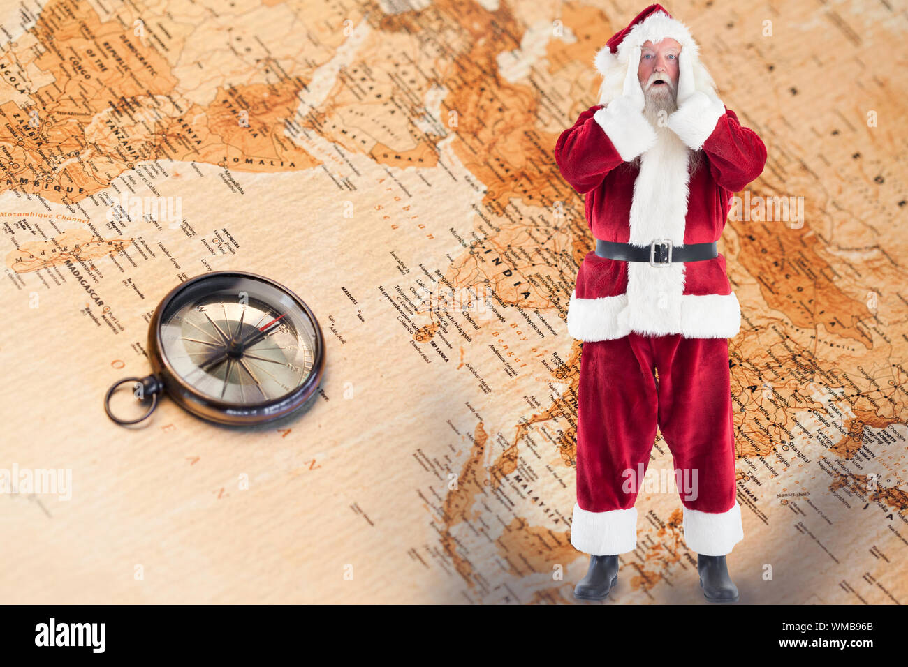 Santa is shocked to camera against world map with compass showing ...