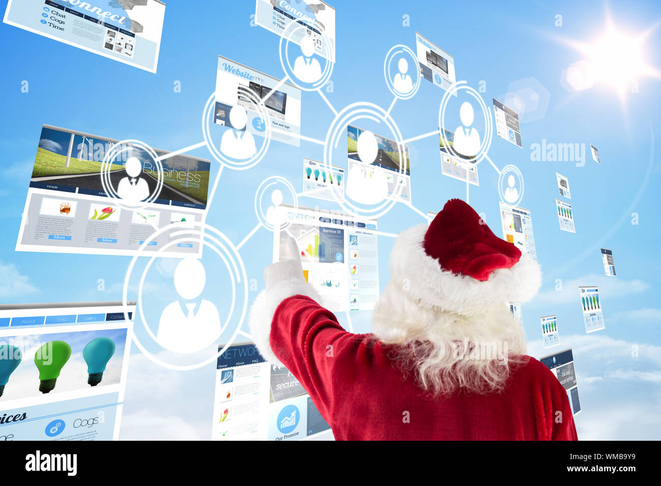 Santa Claus points at something against screens showing business ...