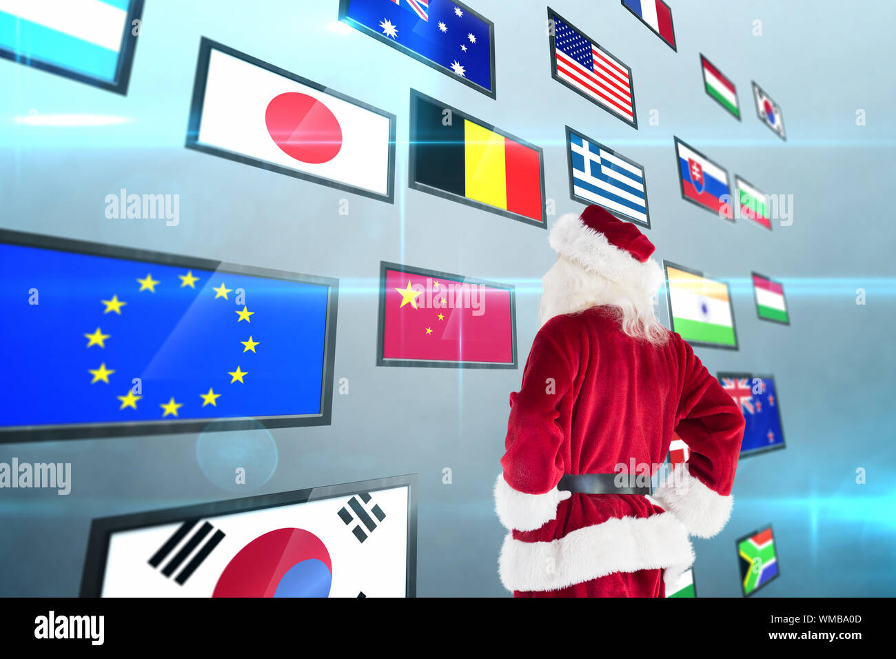 Santa looks away from the camera against screen collage showing ...