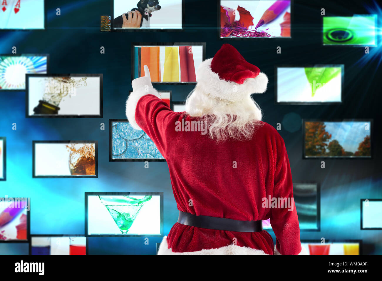 Santa Claus points at something against screen collage showing ...