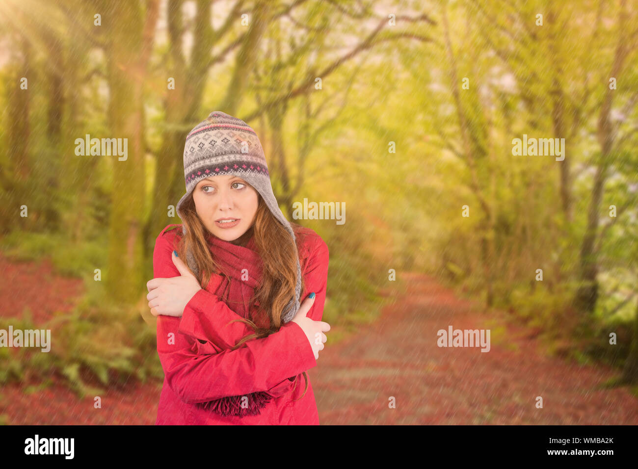 Cold redhead wearing coat and hat against peaceful autumn scene in ...