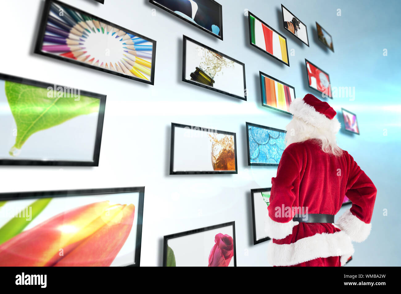 Santa looks away from the camera against screen collage showing ...