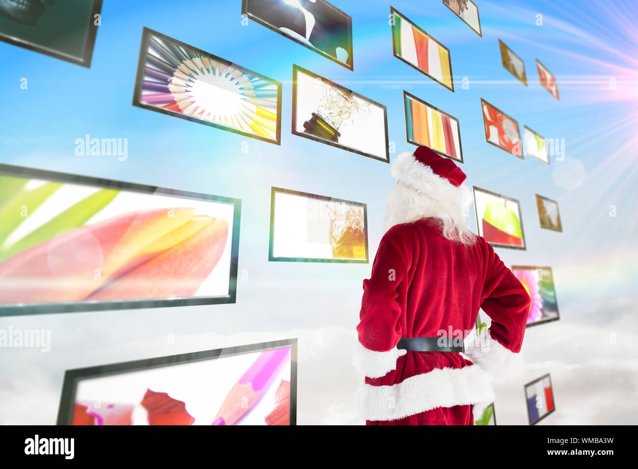 Santa looks away from the camera against screen collage showing ...