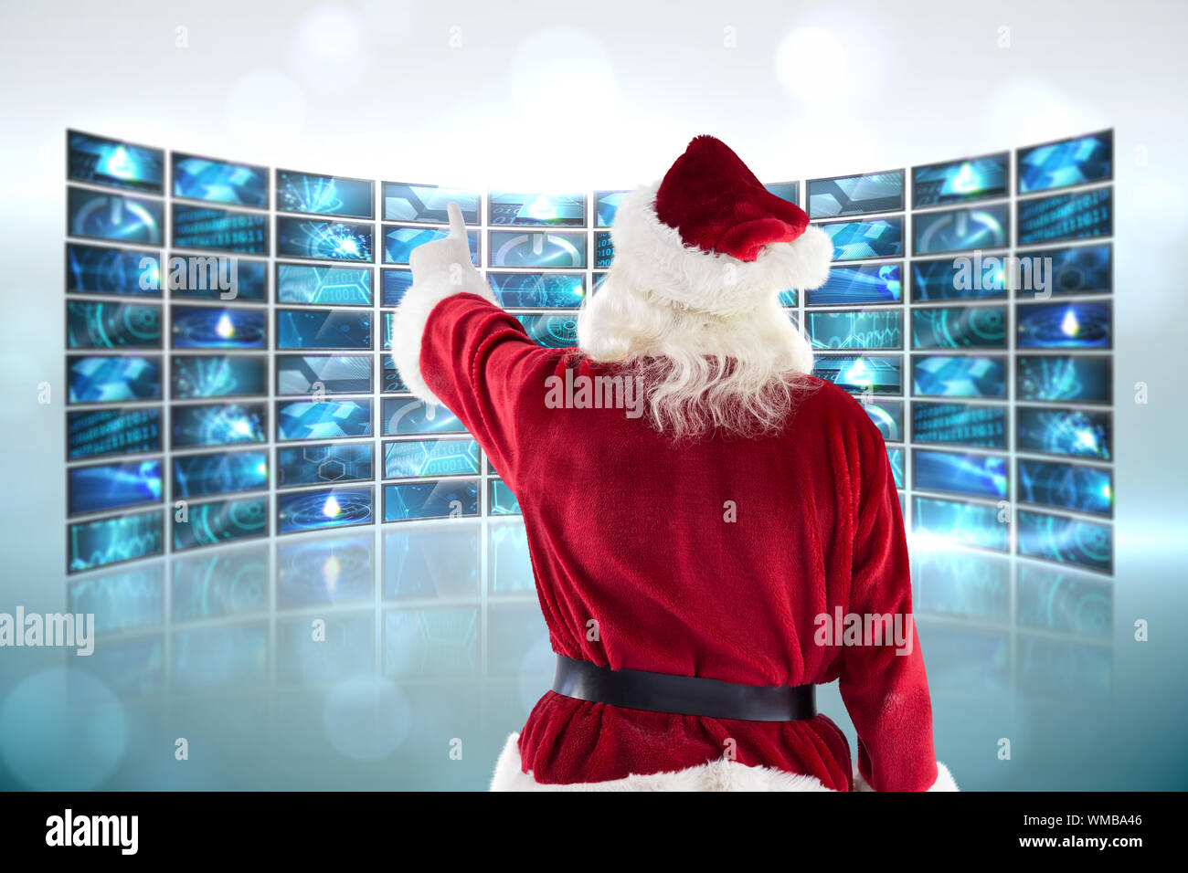 Santa Claus points at something against screen collage showing ...
