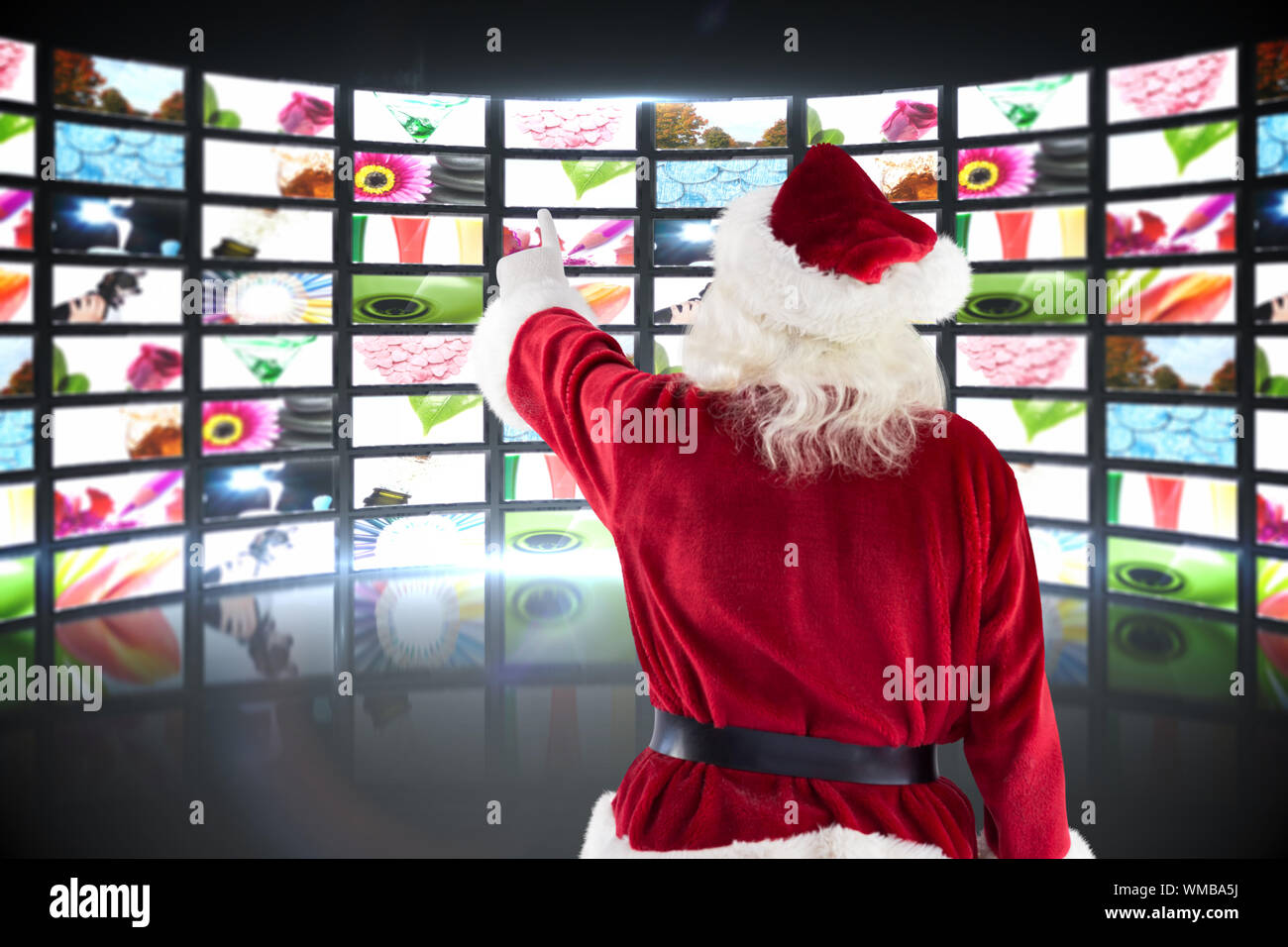 Santa Claus points at something against screen collage showing ...