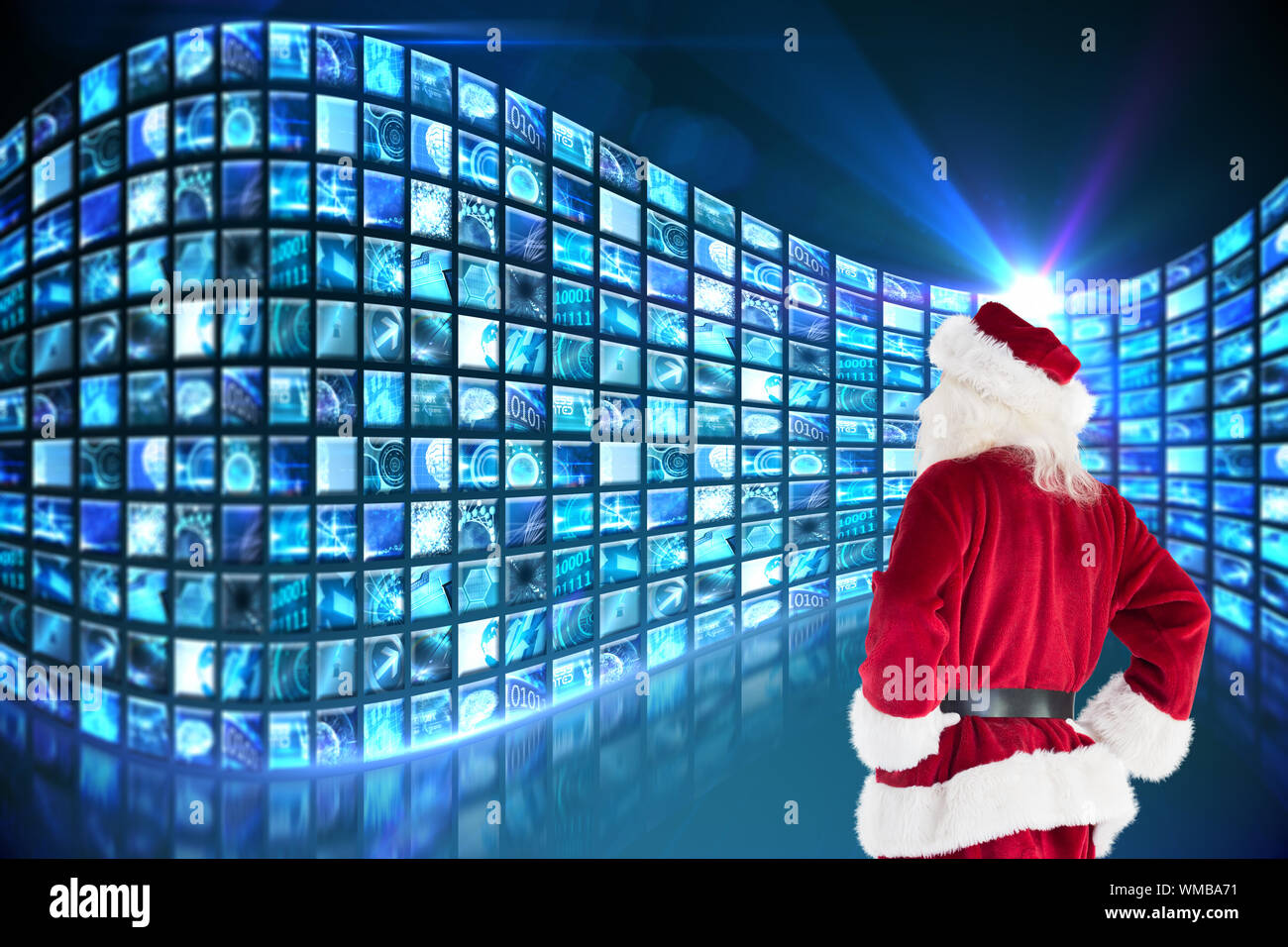 Santa looks away from the camera against curve of digital screens in ...