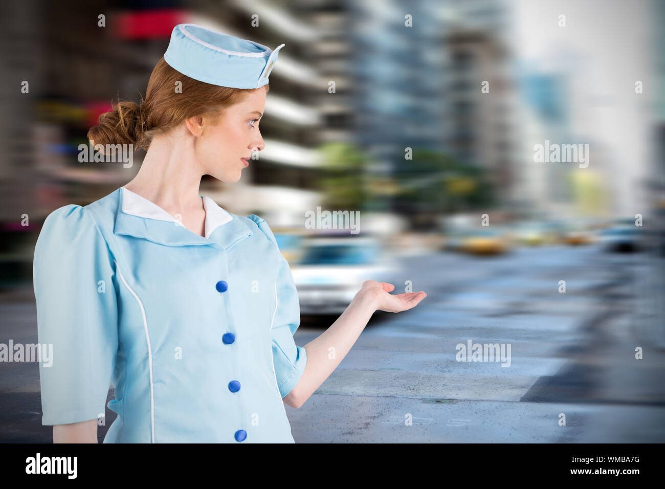 Pretty air hostess presenting with hand against new york street Stock ...