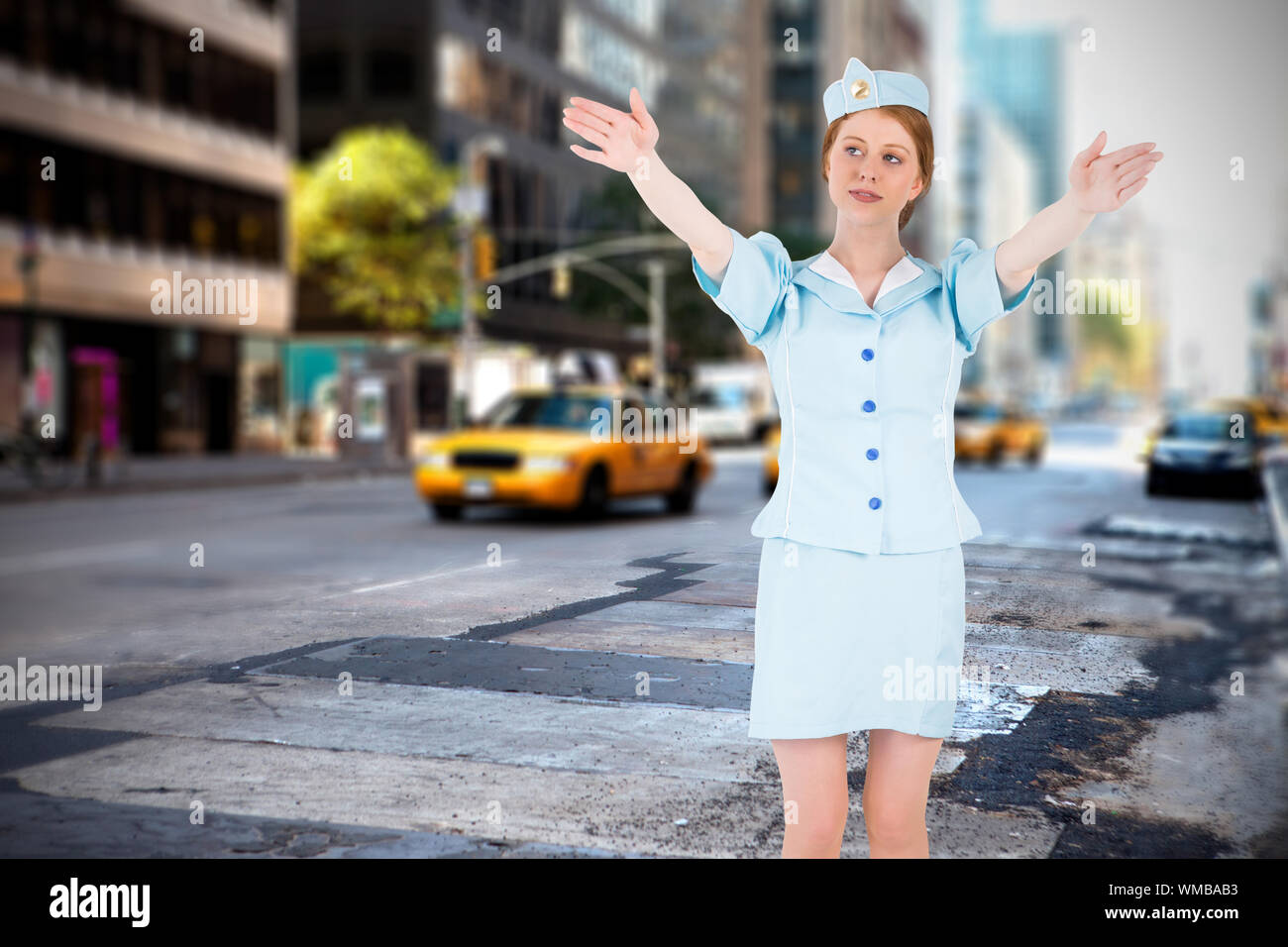 Pretty air hostess with arms raised against new york street Stock Photo ...