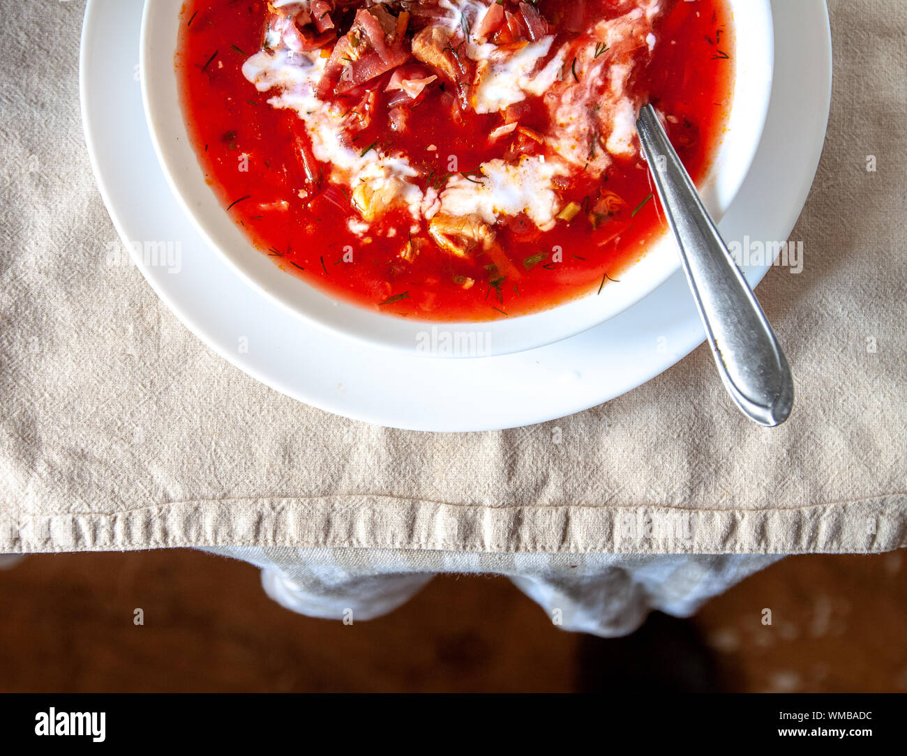 traditional Ukrainian-Russian tomato borscht soup with sour cream in a ...