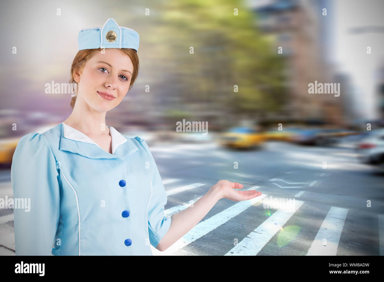 Pretty air hostess presenting with hand against new york street Stock ...