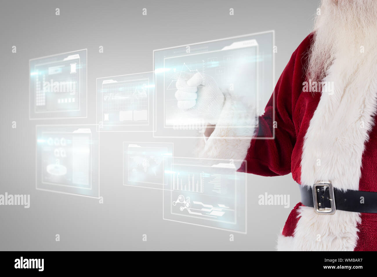 Santa Claus points at something against grey vignette Stock Photo - Alamy