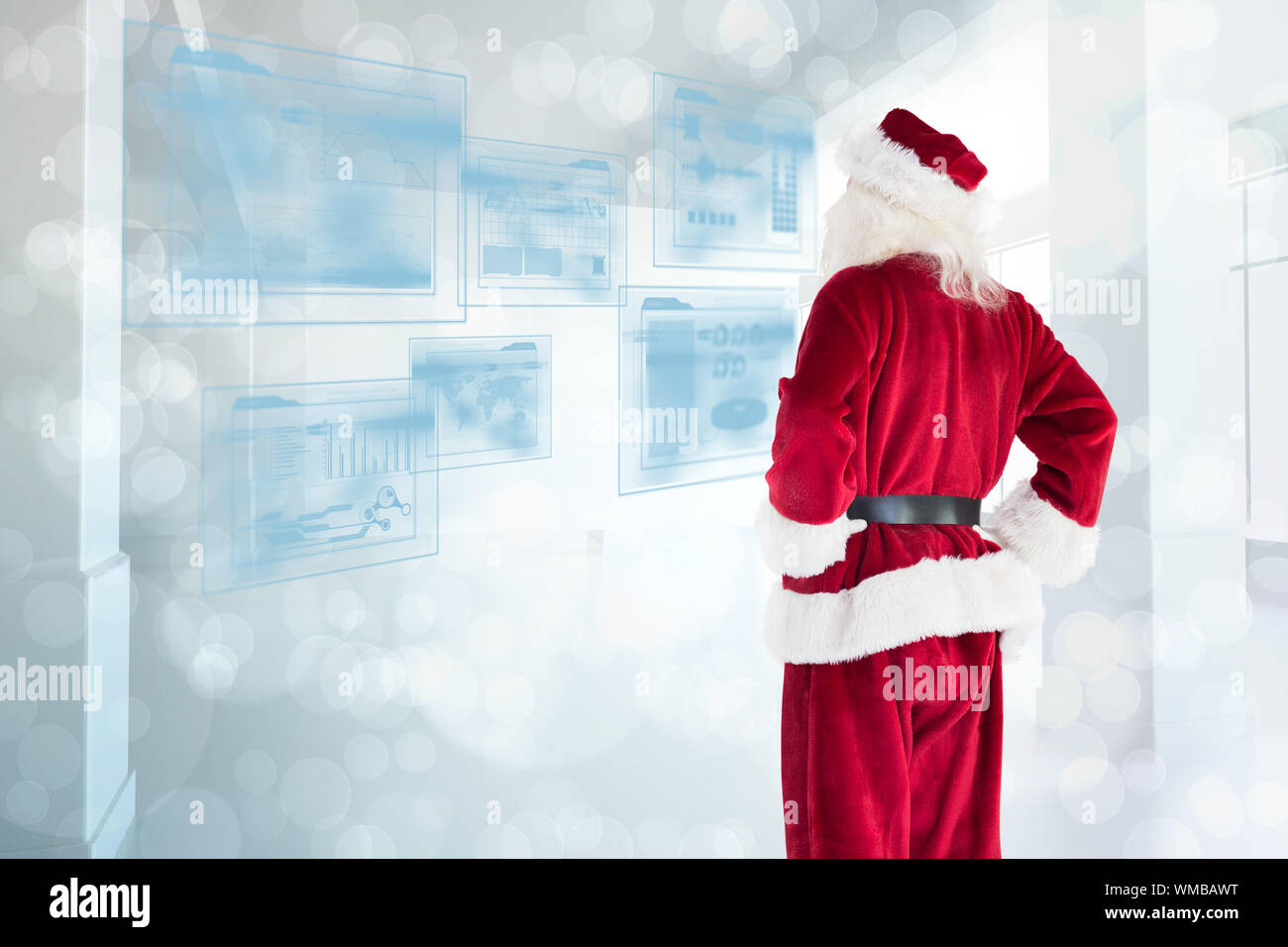 Santa looks away from the camera against lights in modern room Stock ...