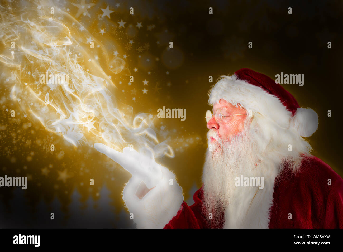 Santa claus blowing against blurred fir tree background Stock Photo - Alamy