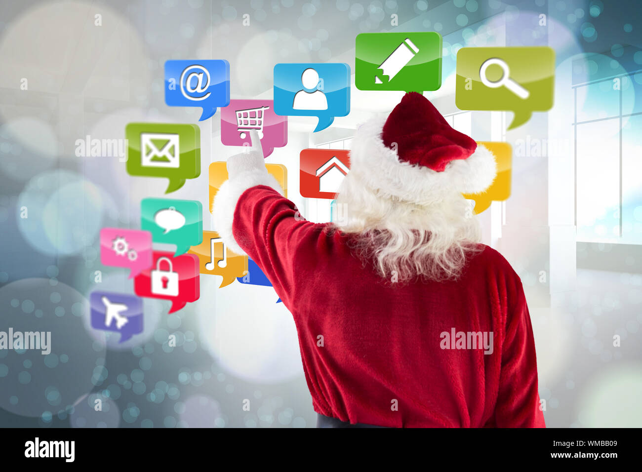 Santa Claus points at something against lights glowing in modern room ...