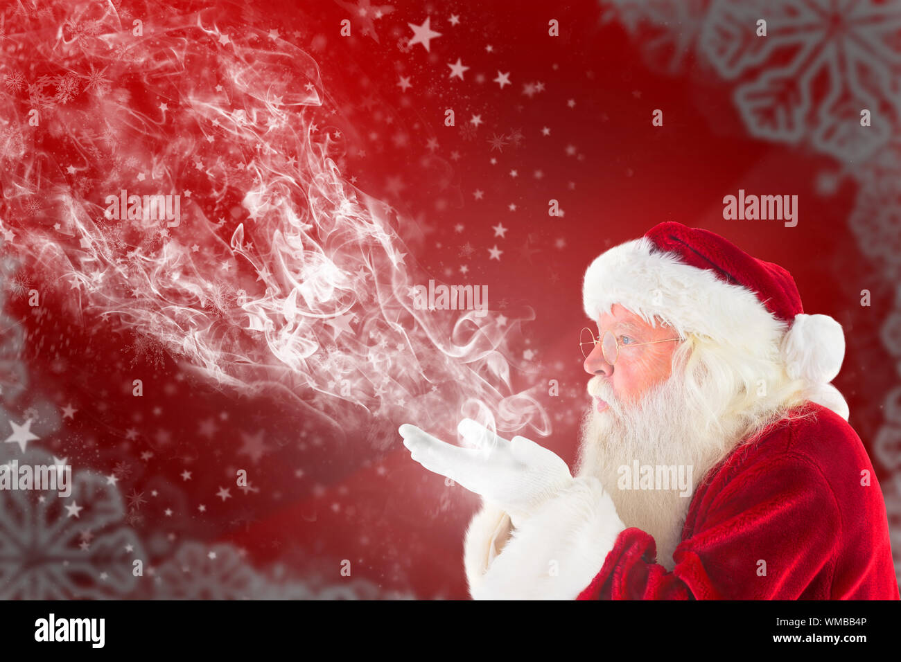 Santa Claus blows something away against blurred christmas frame Stock ...
