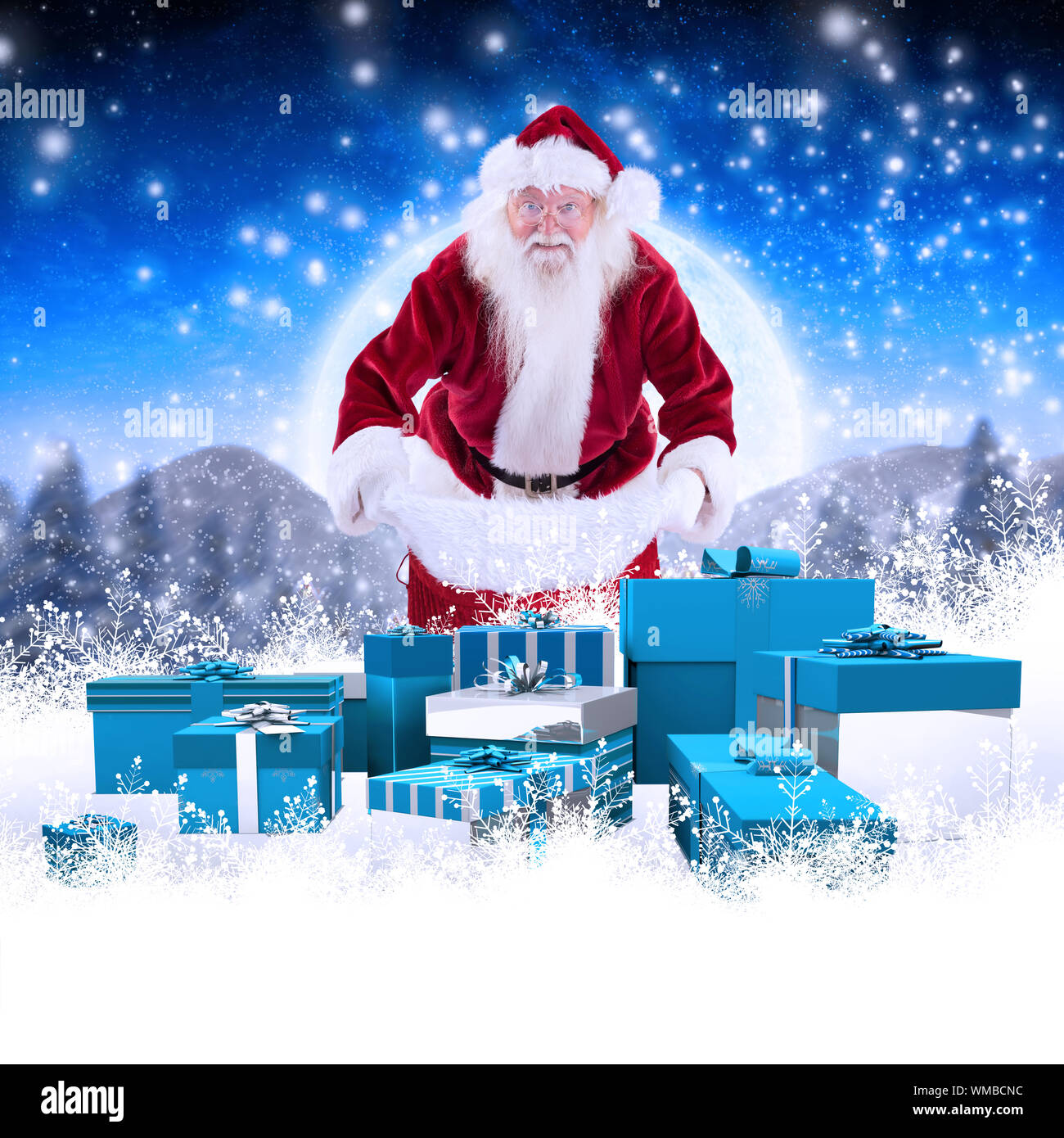 Santa open his red bag against cute christmas village under huge full ...