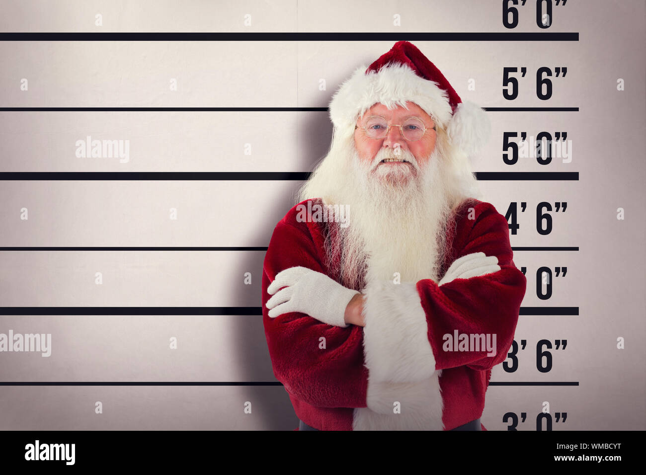 Santa smiles with folded arms against mug shot background Stock Photo ...