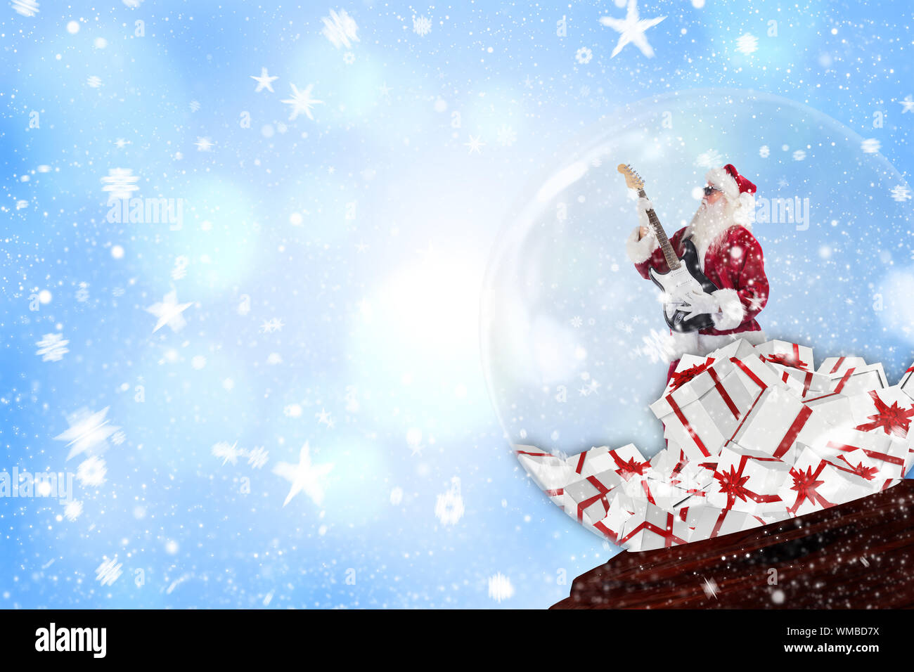 Santa rocking out in snow globe against blue abstract light spot design ...