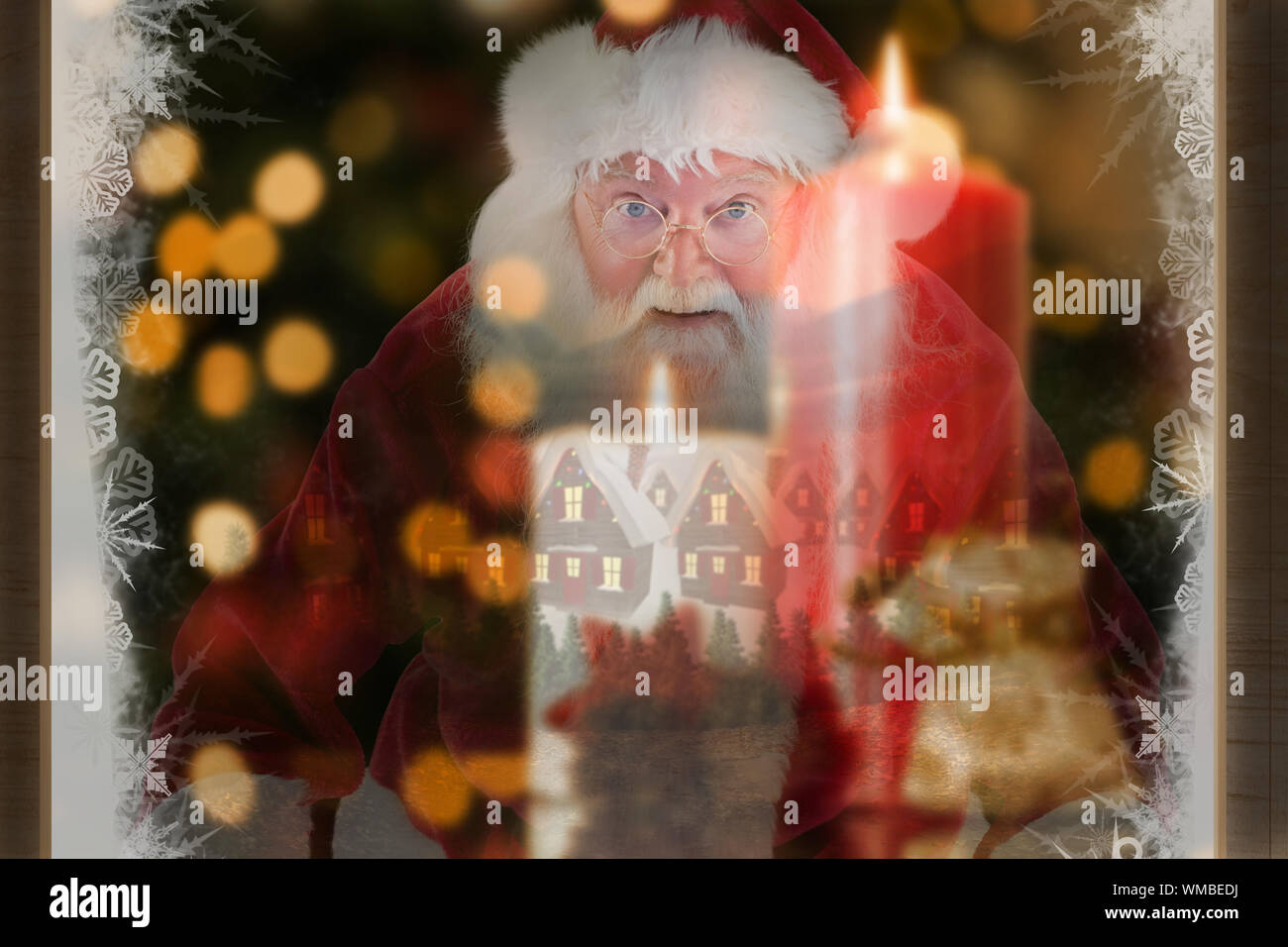 Santa open his red bag against focus on christmas candles and ...