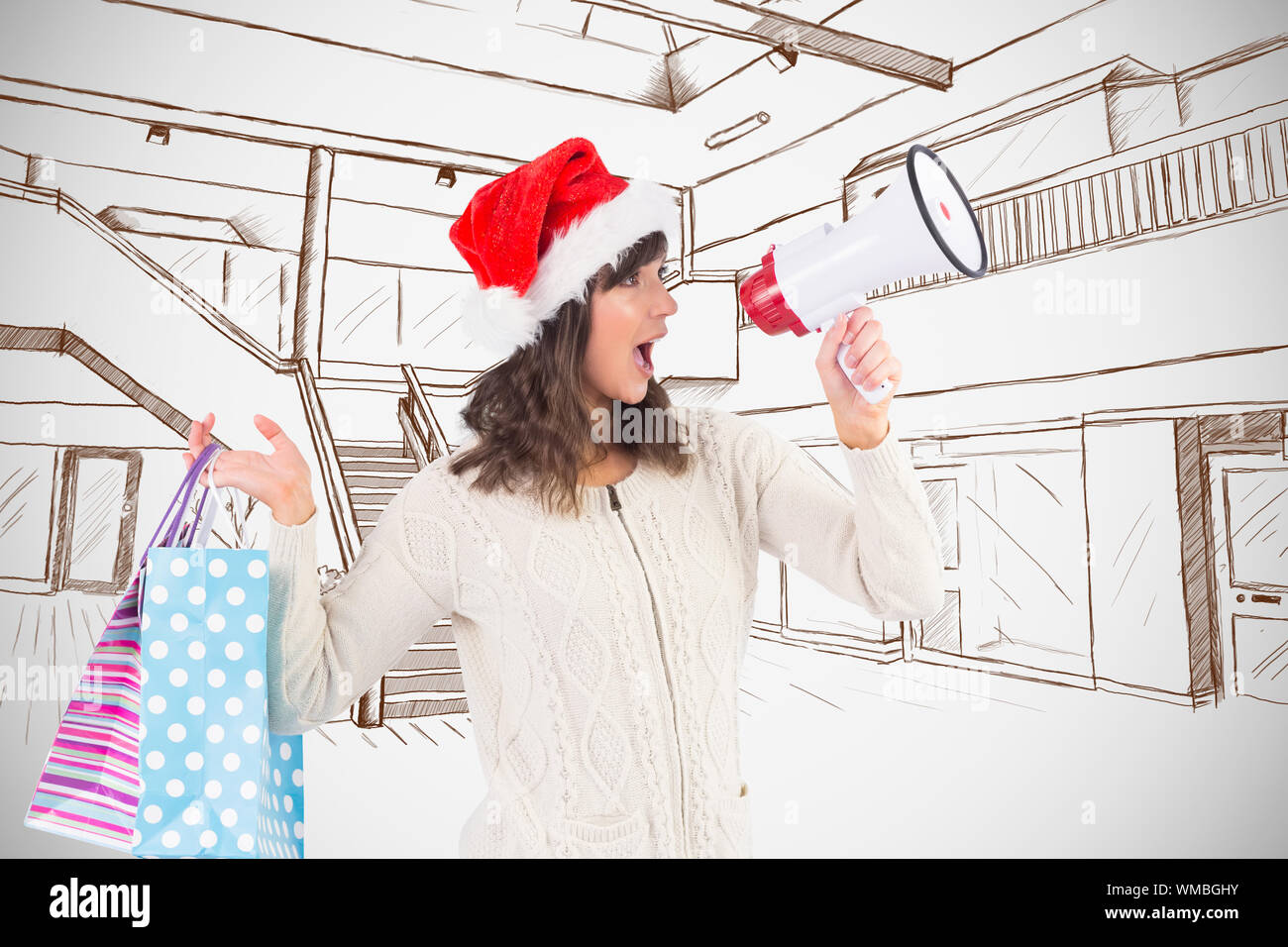 Festive brunette holding megaphone and bags against white background ...