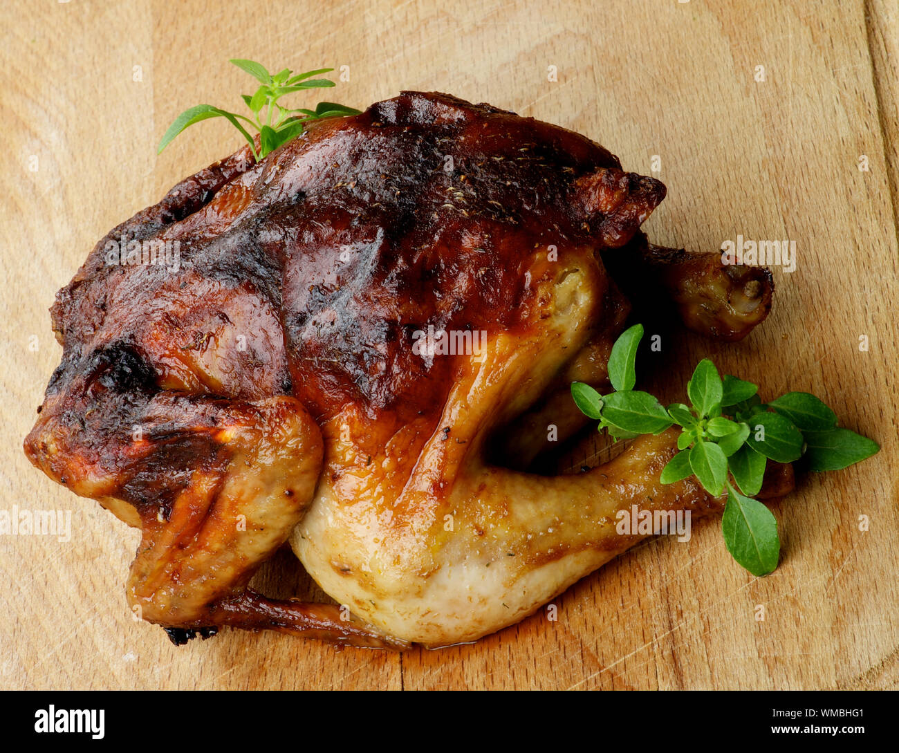 Roasted Chicken Full Body with Fresh Basil Leafs closeup on Wooden ...