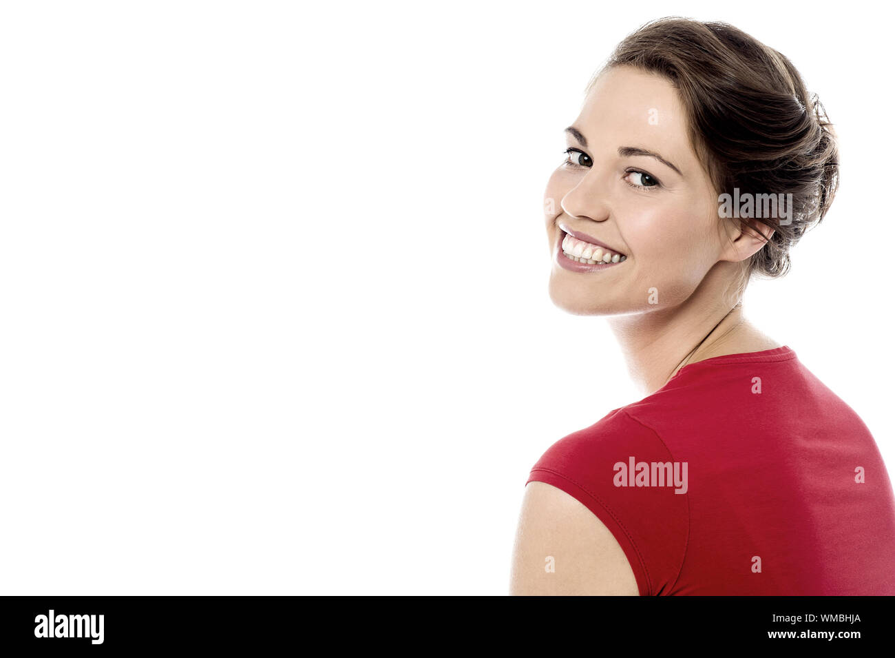 Beautiful smiling woman looking over her shoulder Stock Photo - Alamy