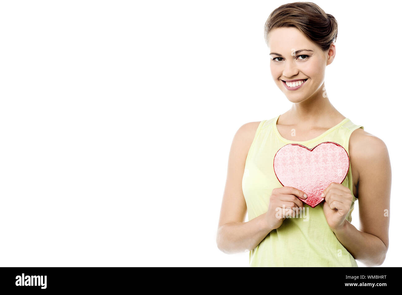 Smiling young woman showing heart Cut Out Stock Images & Pictures - Alamy