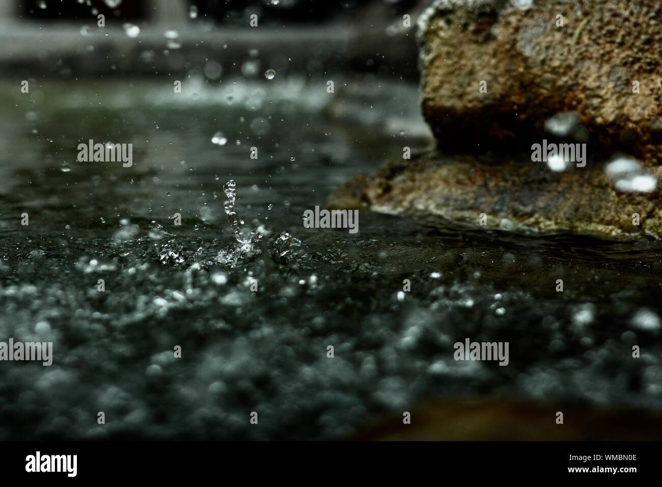 Raindrops in puddle hi-res stock photography and images - Alamy