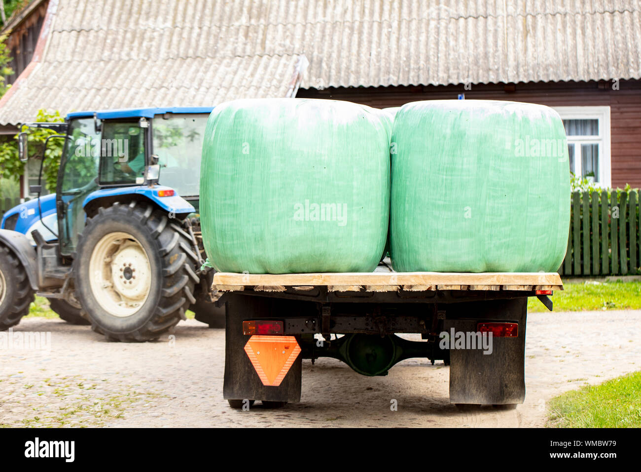 tractor transports hay bales on a trailer Stock Photo - Alamy